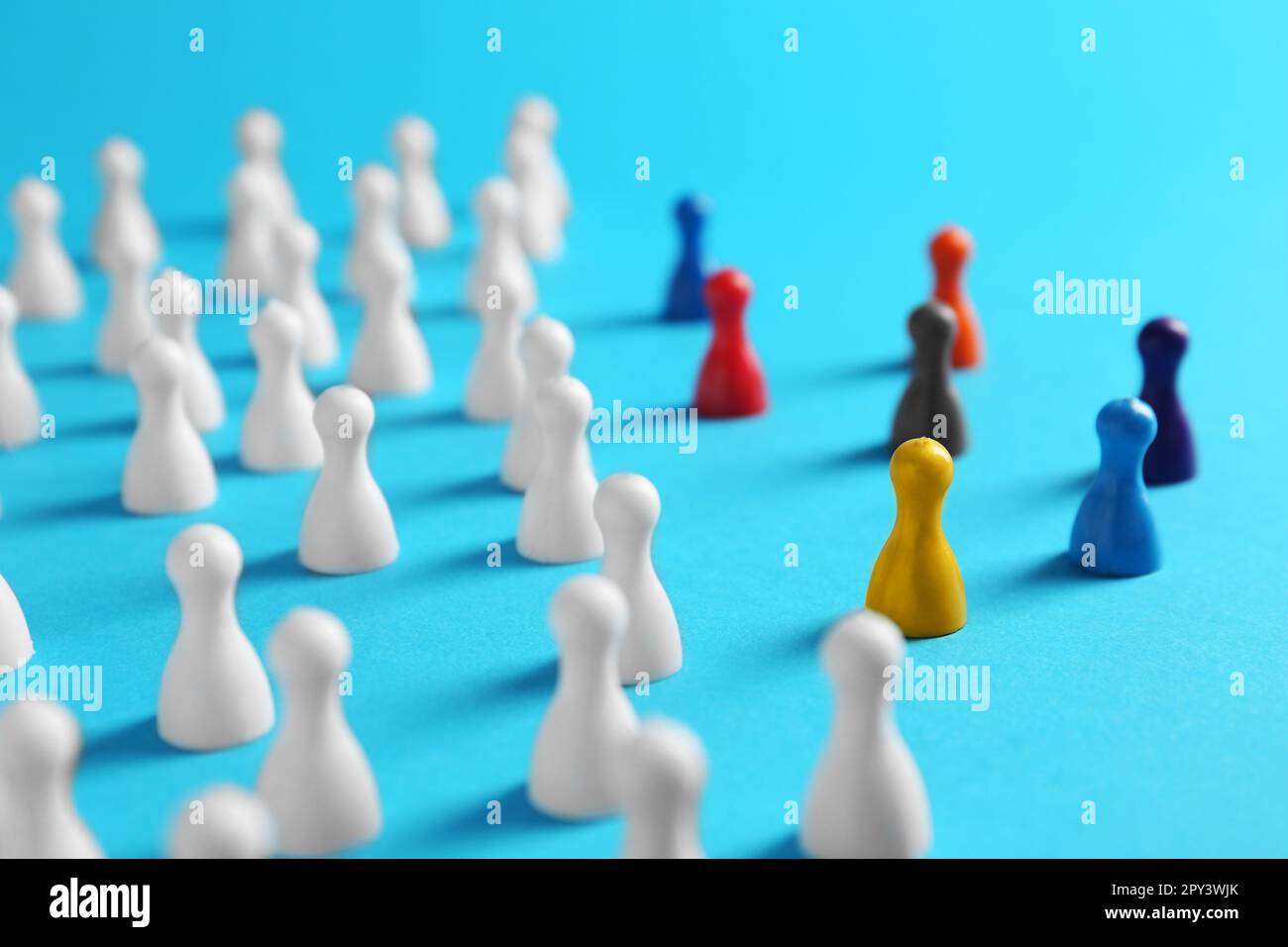 Colorful pawns on light blue background. Social inclusion concept Stock ...