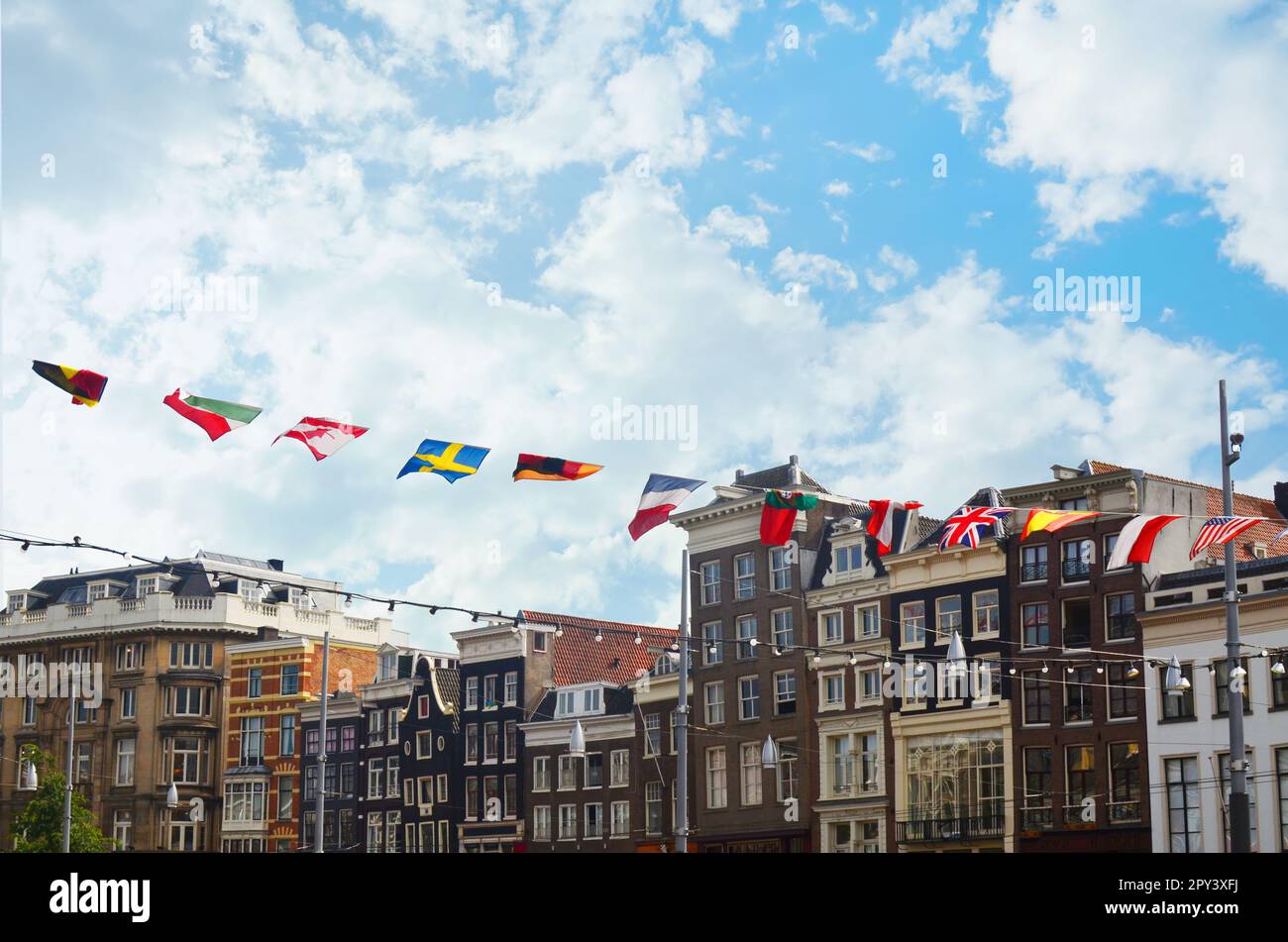 Modern buildings and rope with country flags outdoors Stock Photo - Alamy