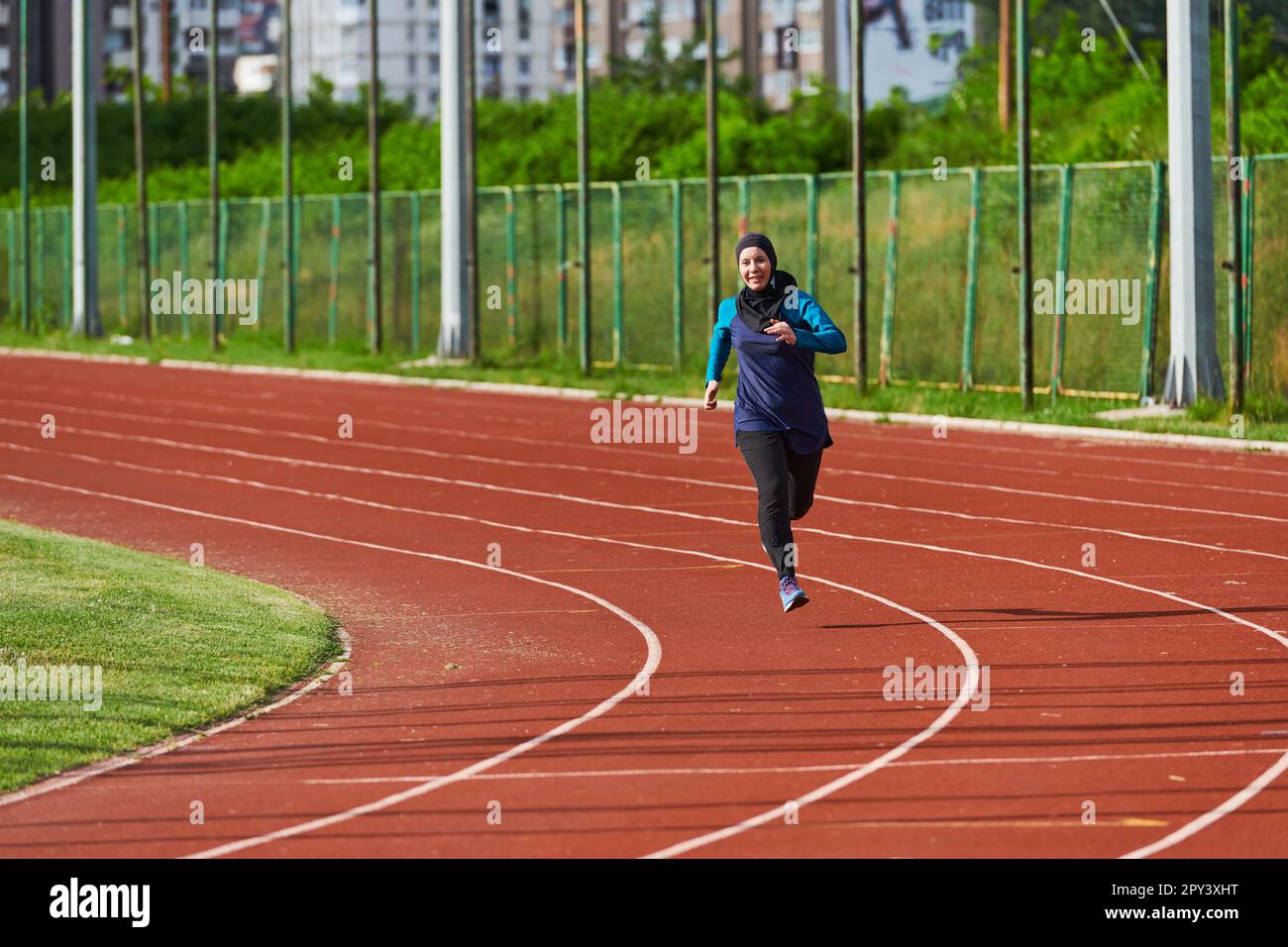 A muslim woman in a burqa sports muslim clothes running on a marathon ...