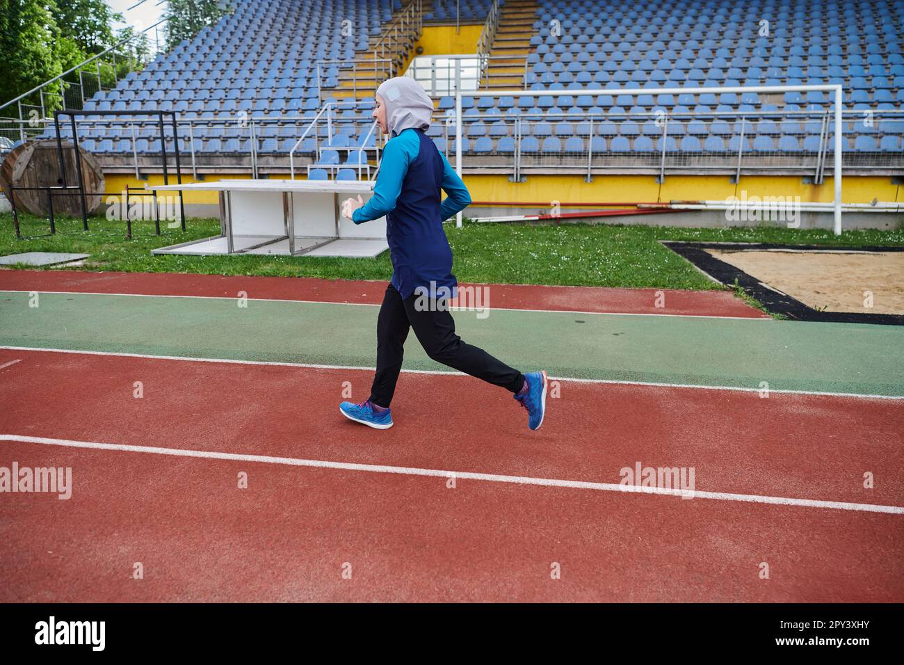A muslim woman in a burqa sports muslim clothes running on a marathon ...