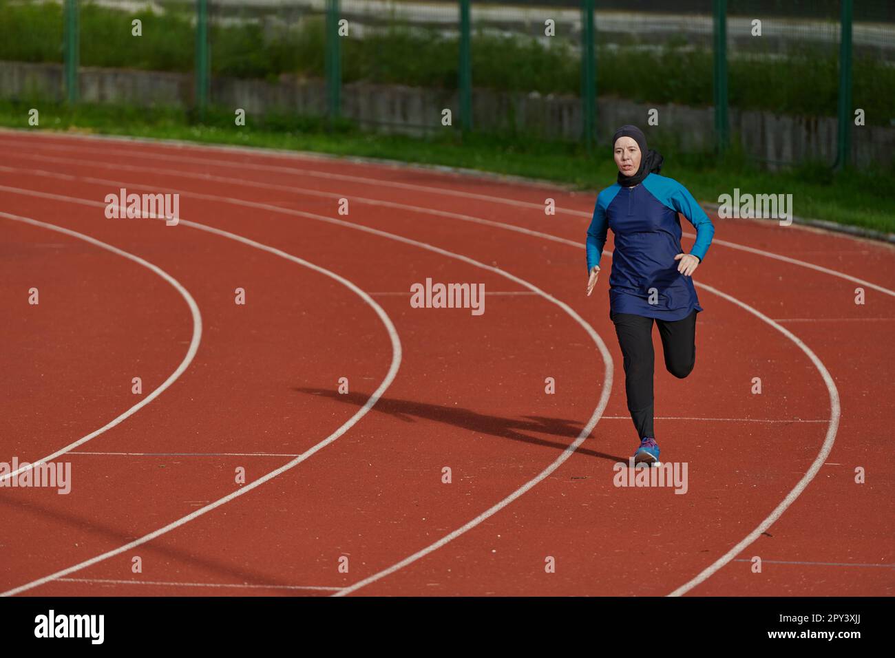 A muslim woman in a burqa sports muslim clothes running on a marathon ...