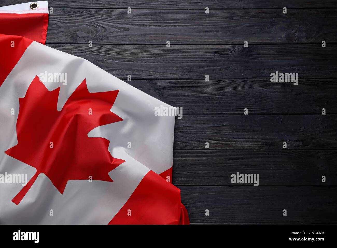 Flag of Canada on dark wooden table, top view. Space for text Stock ...