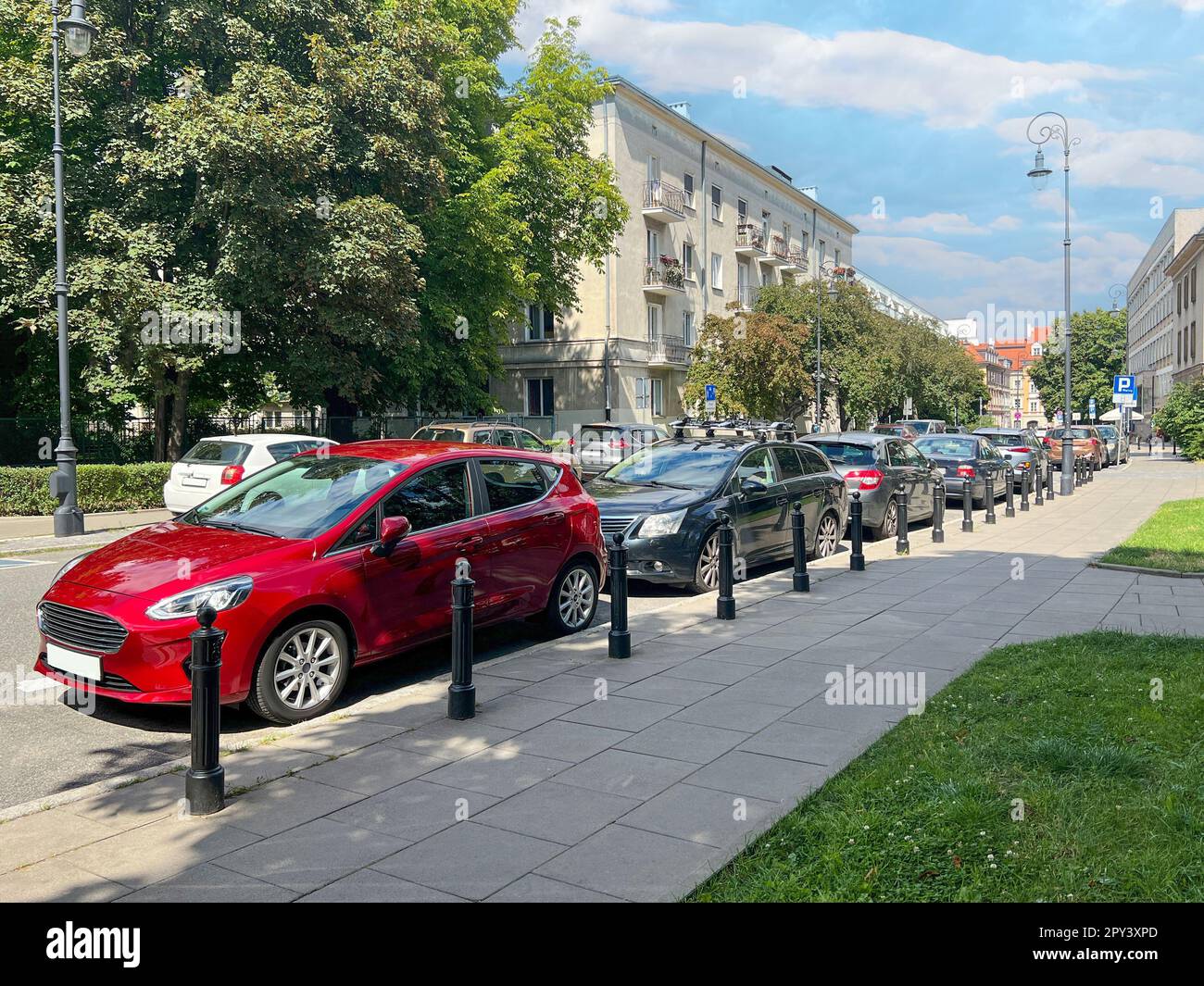 Different modern cars parked on city street Stock Photo - Alamy
