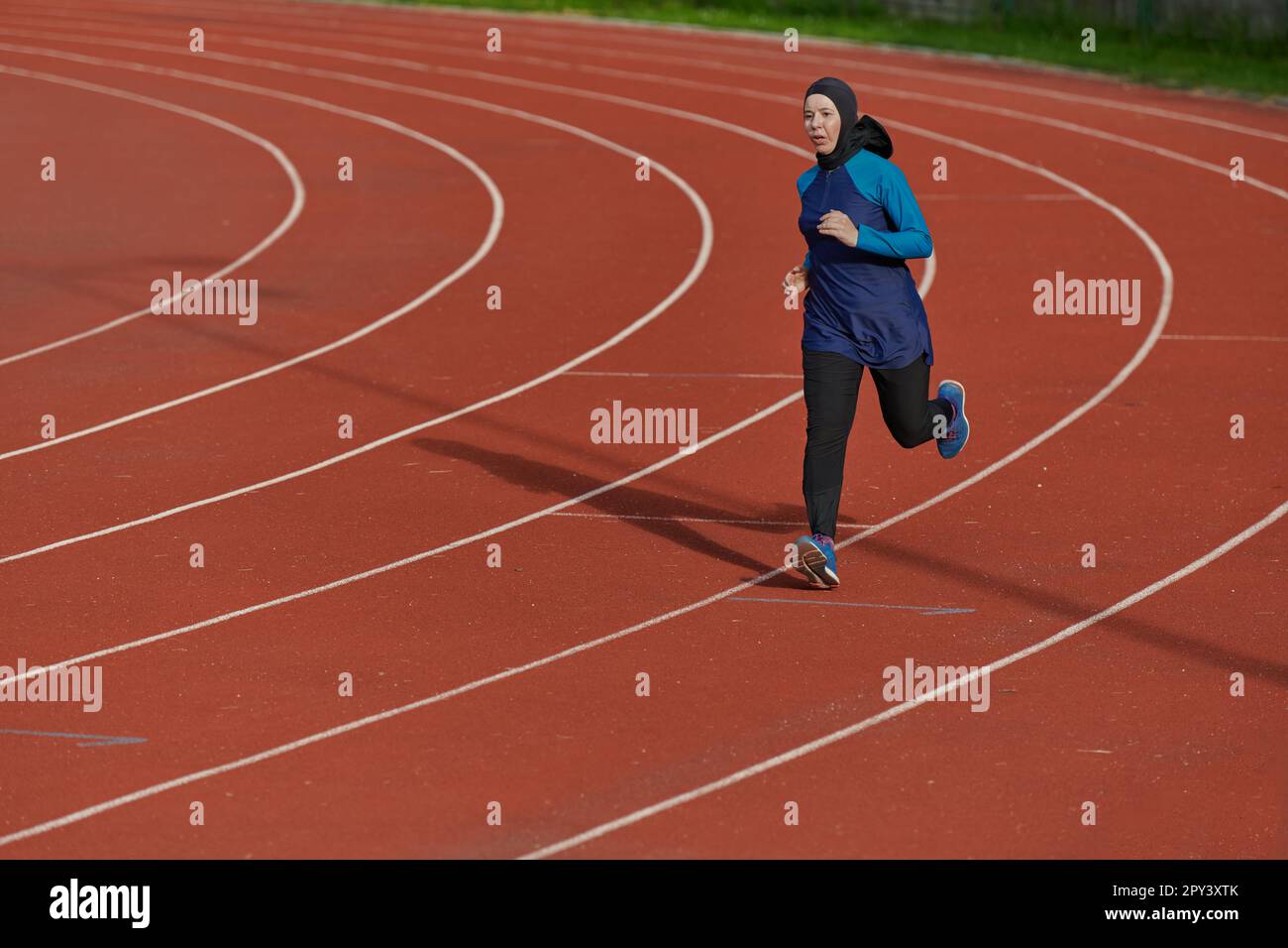 A muslim woman in a burqa sports muslim clothes running on a marathon ...