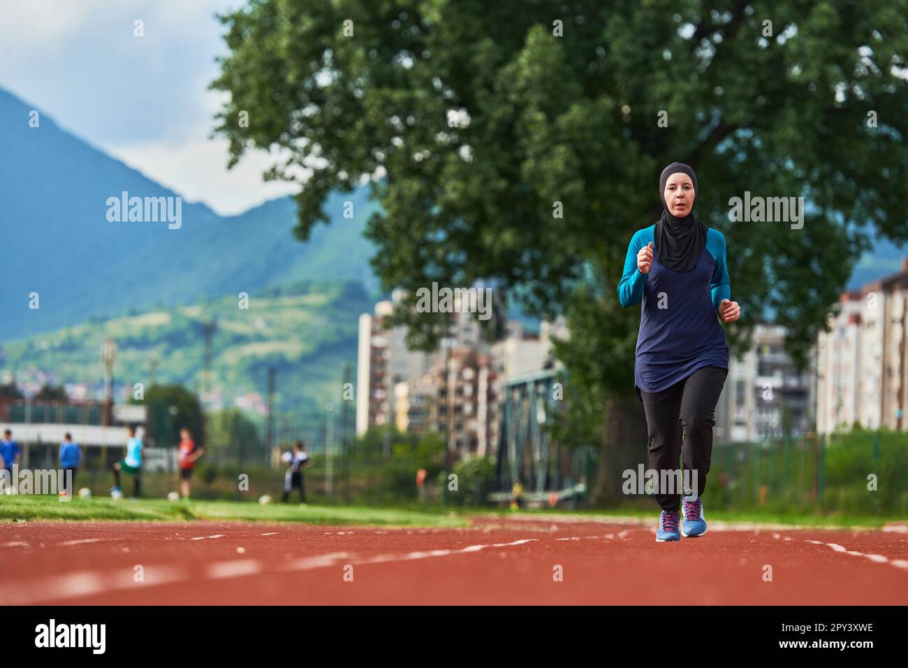 A muslim woman in a burqa sports muslim clothes running on a marathon ...