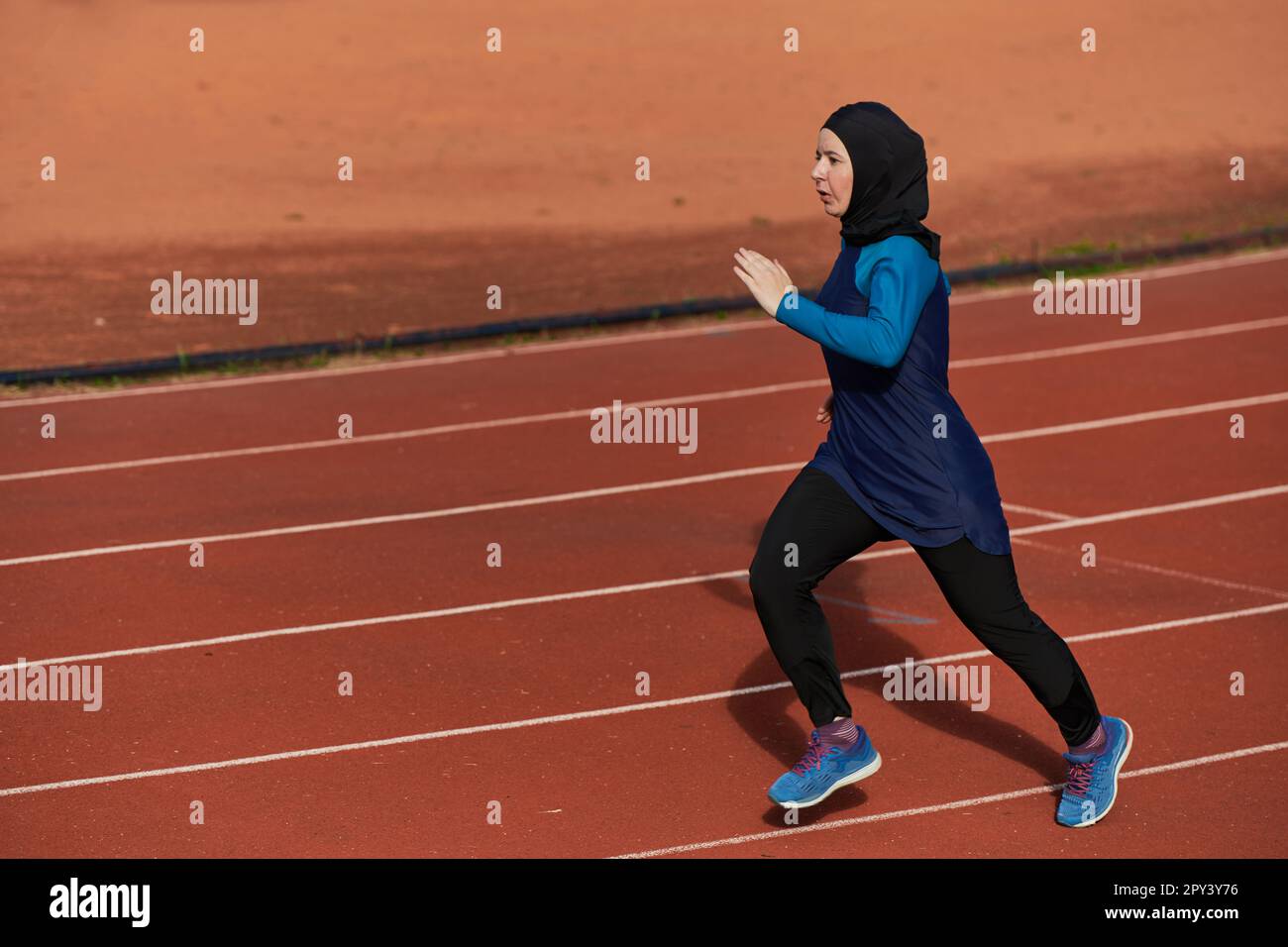 A muslim woman in a burqa sports muslim clothes running on a marathon ...