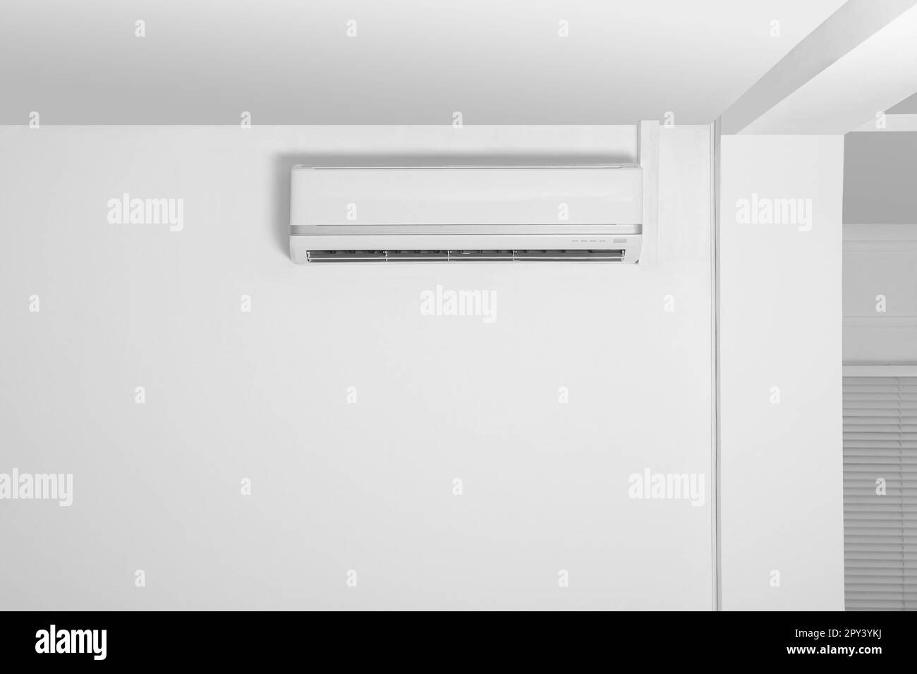 Modern air conditioner on white wall indoors Stock Photo - Alamy