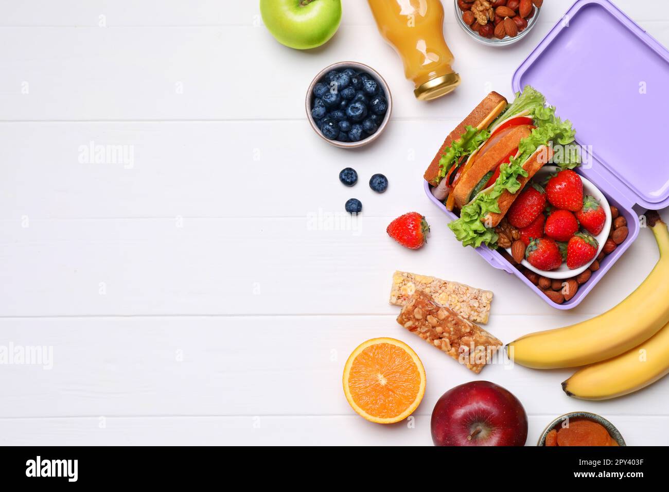 Lunch box with healthy food on white wooden table, flat lay. Space for ...