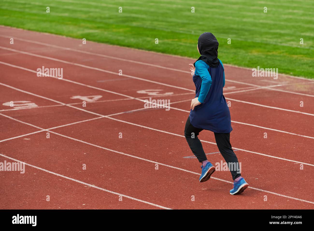 A muslim woman in a burqa sports muslim clothes running on a marathon ...