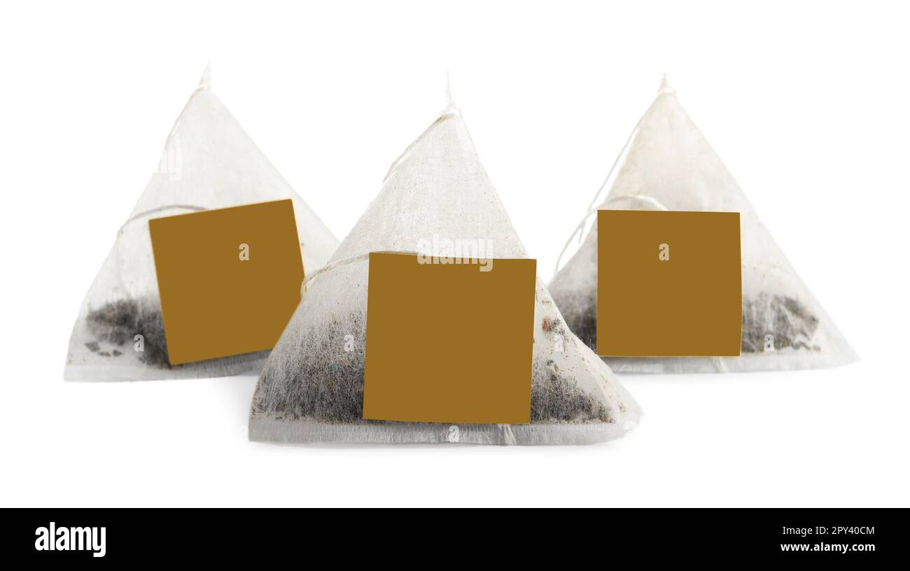 New pyramid tea bags on white background Stock Photo - Alamy