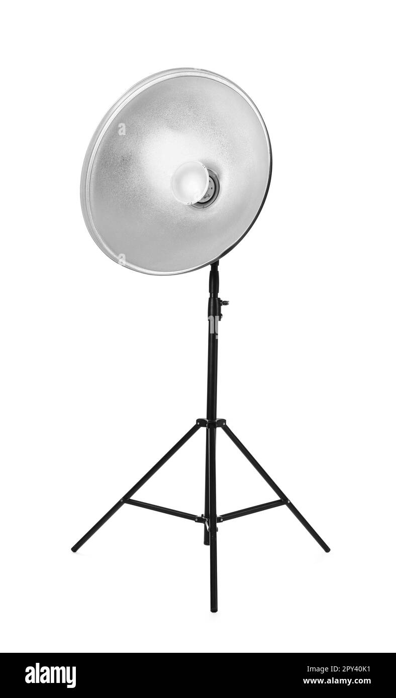 Studio flash light with reflector on tripod against white background ...