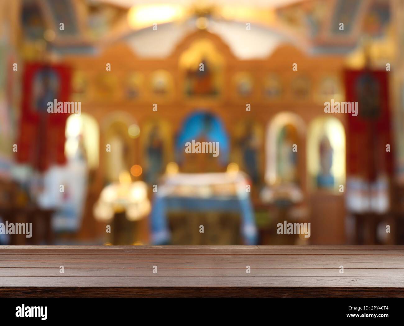 Empty wooden table and blurred view of beautiful church interior, space ...