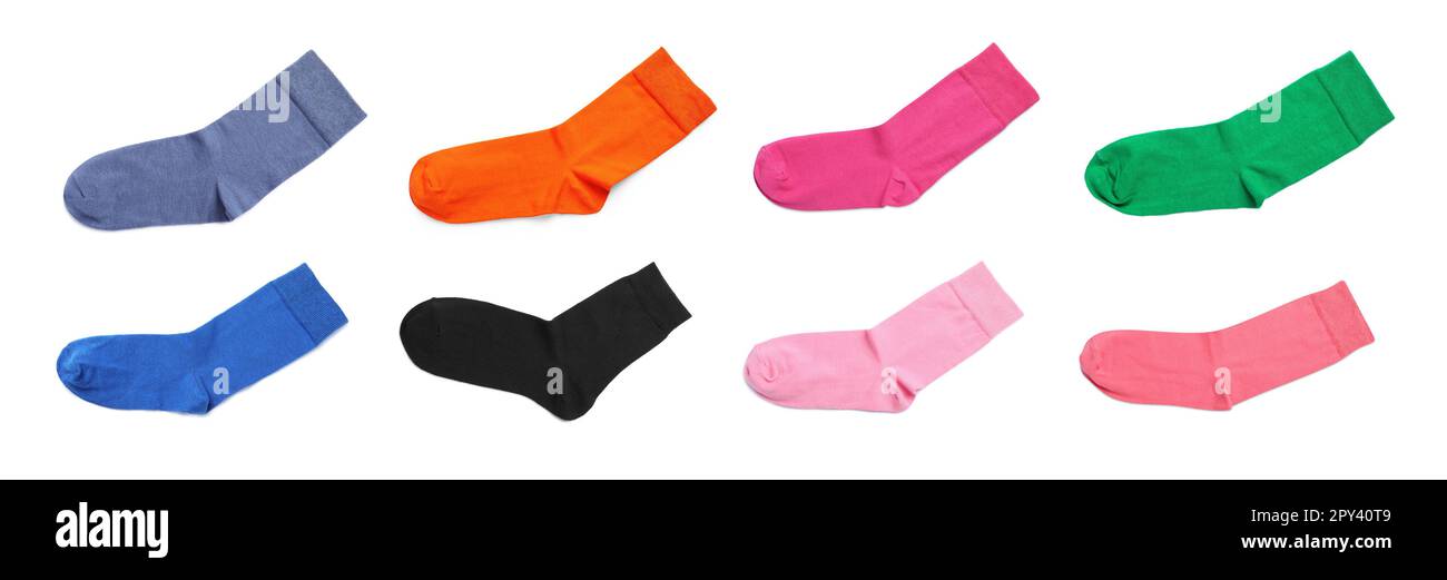 Set with pairs of different color socks on white background, top view ...