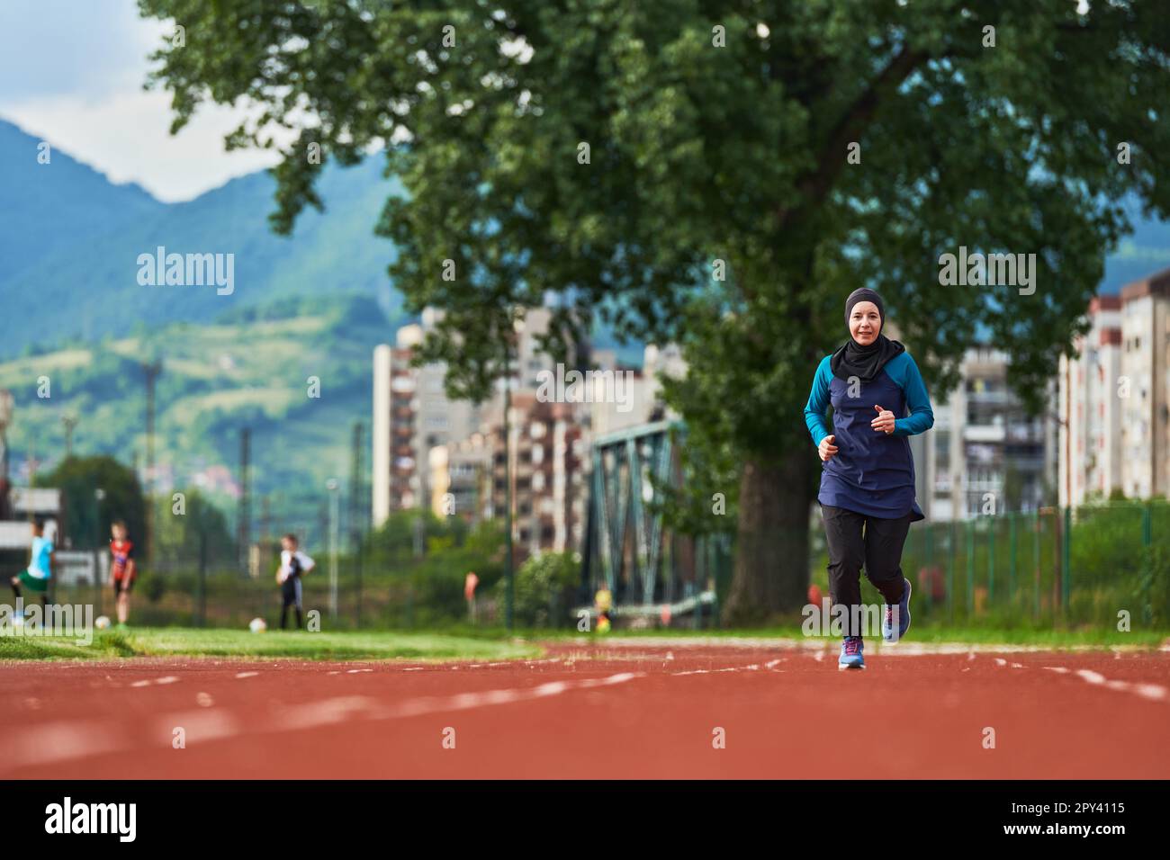 A muslim woman in a burqa sports muslim clothes running on a marathon ...
