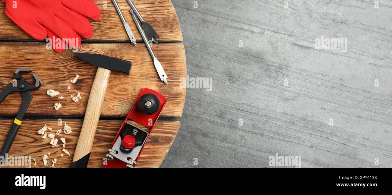 Different carpenter's tools on grey stone background, flat lay with ...