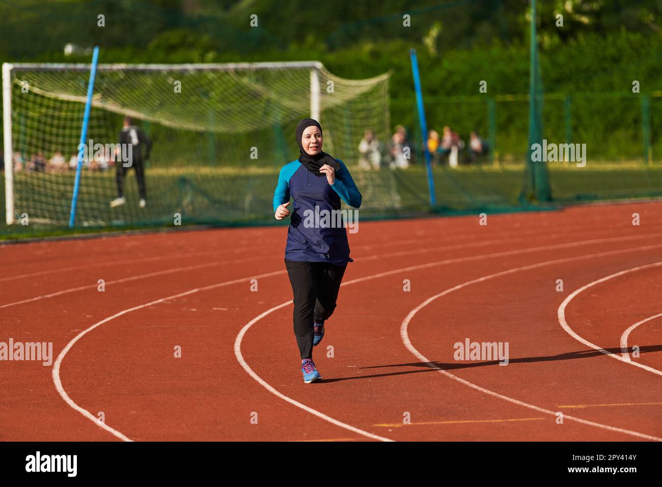 A muslim woman in a burqa sports muslim clothes running on a marathon ...