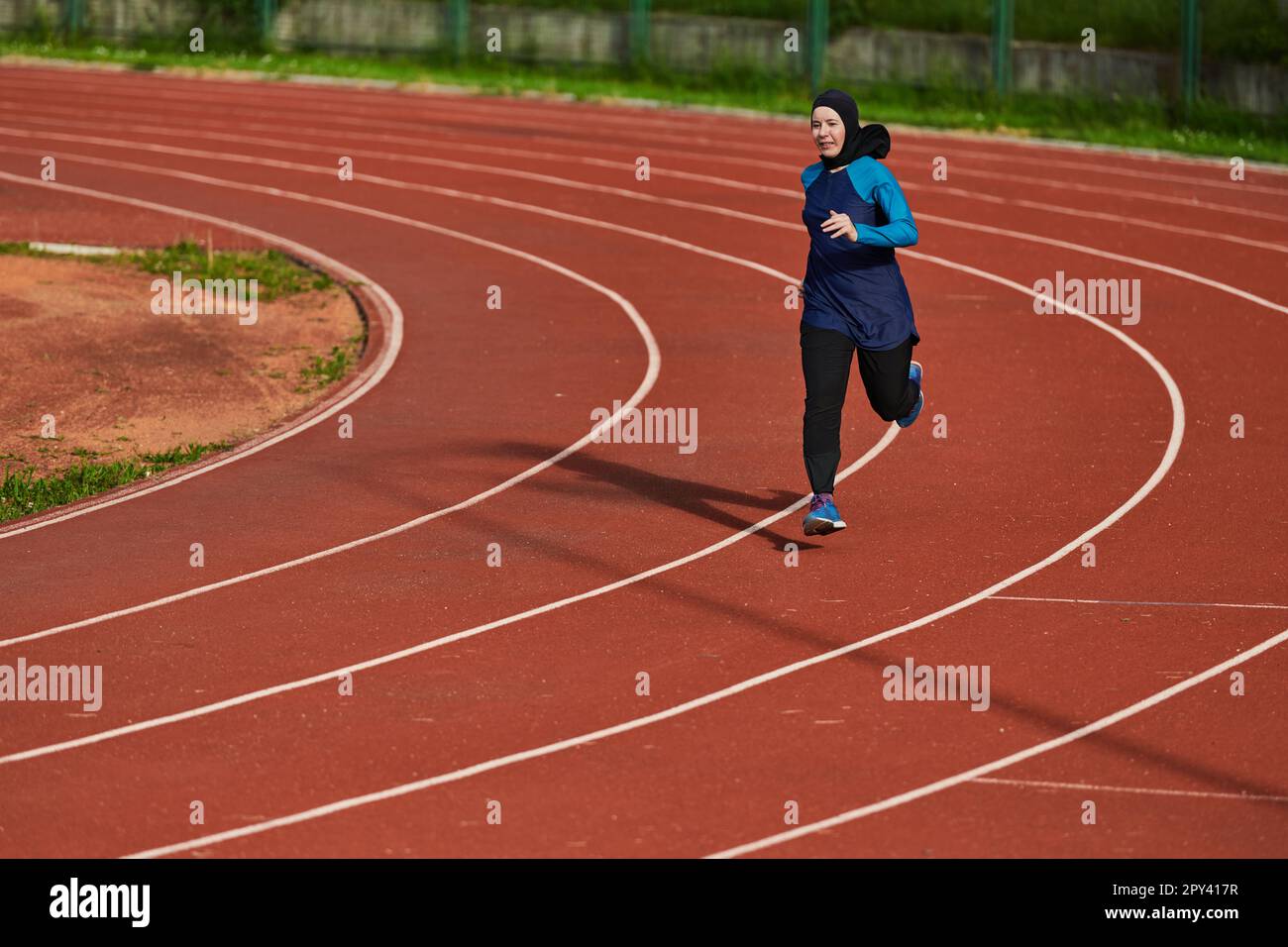 A muslim woman in a burqa sports muslim clothes running on a marathon ...