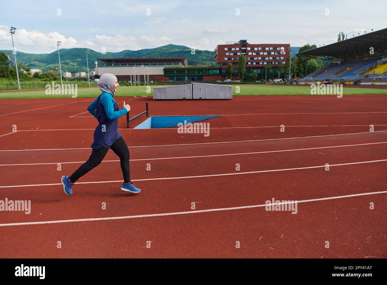 A muslim woman in a burqa sports muslim clothes running on a marathon ...