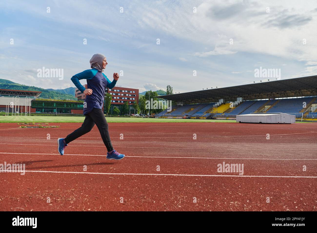 A muslim woman in a burqa sports muslim clothes running on a marathon ...