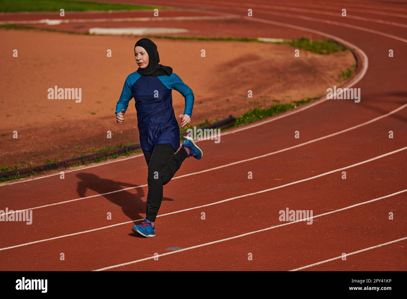 A muslim woman in a burqa sports muslim clothes running on a marathon ...
