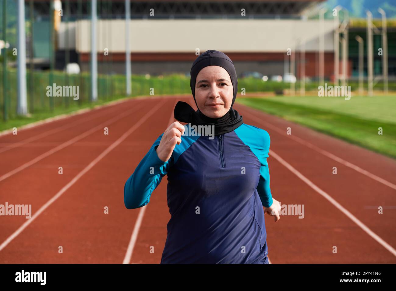 A muslim woman in a burqa sports muslim clothes running on a marathon ...