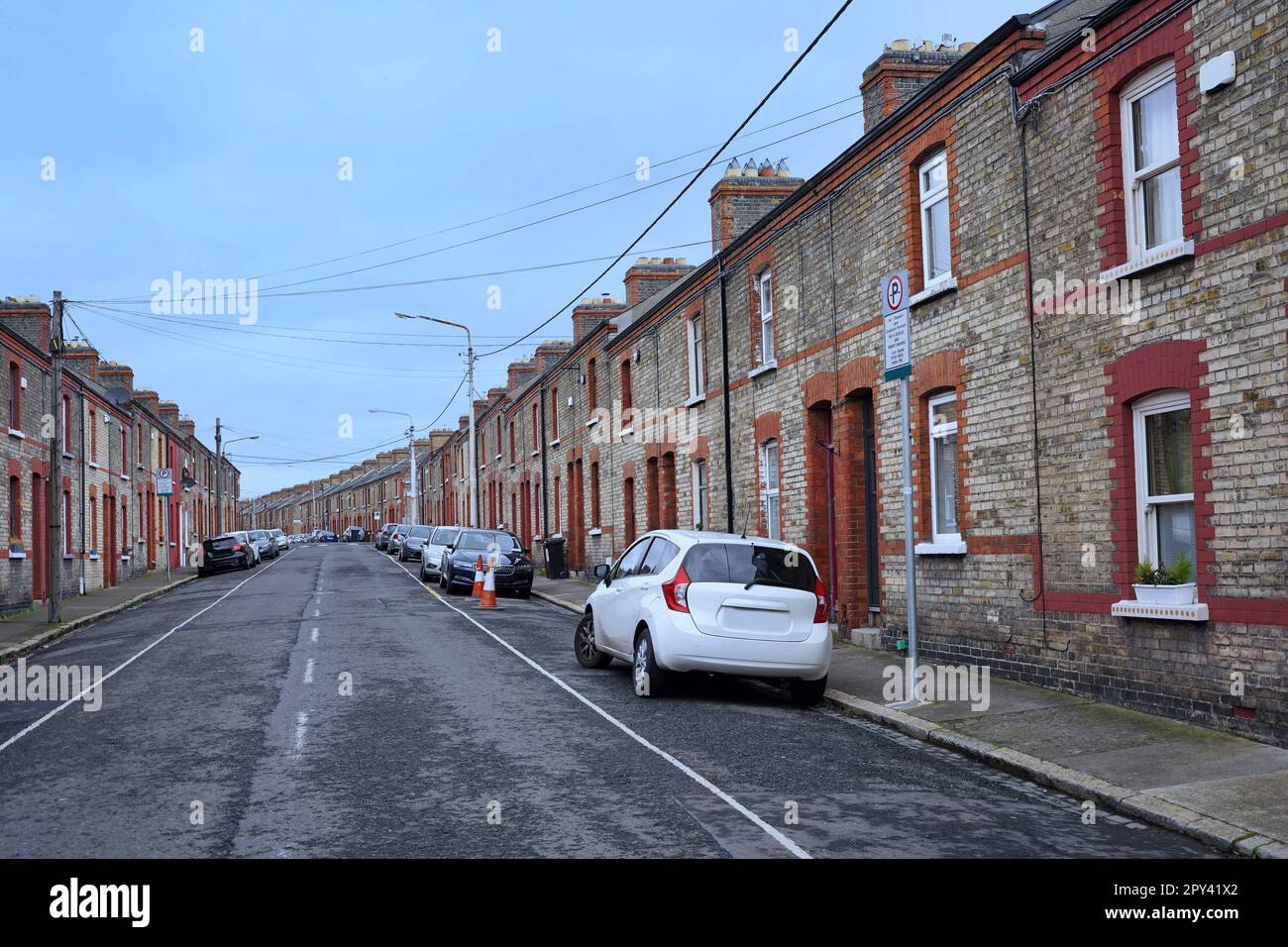 Long street of identical small row houses Stock Photo - Alamy