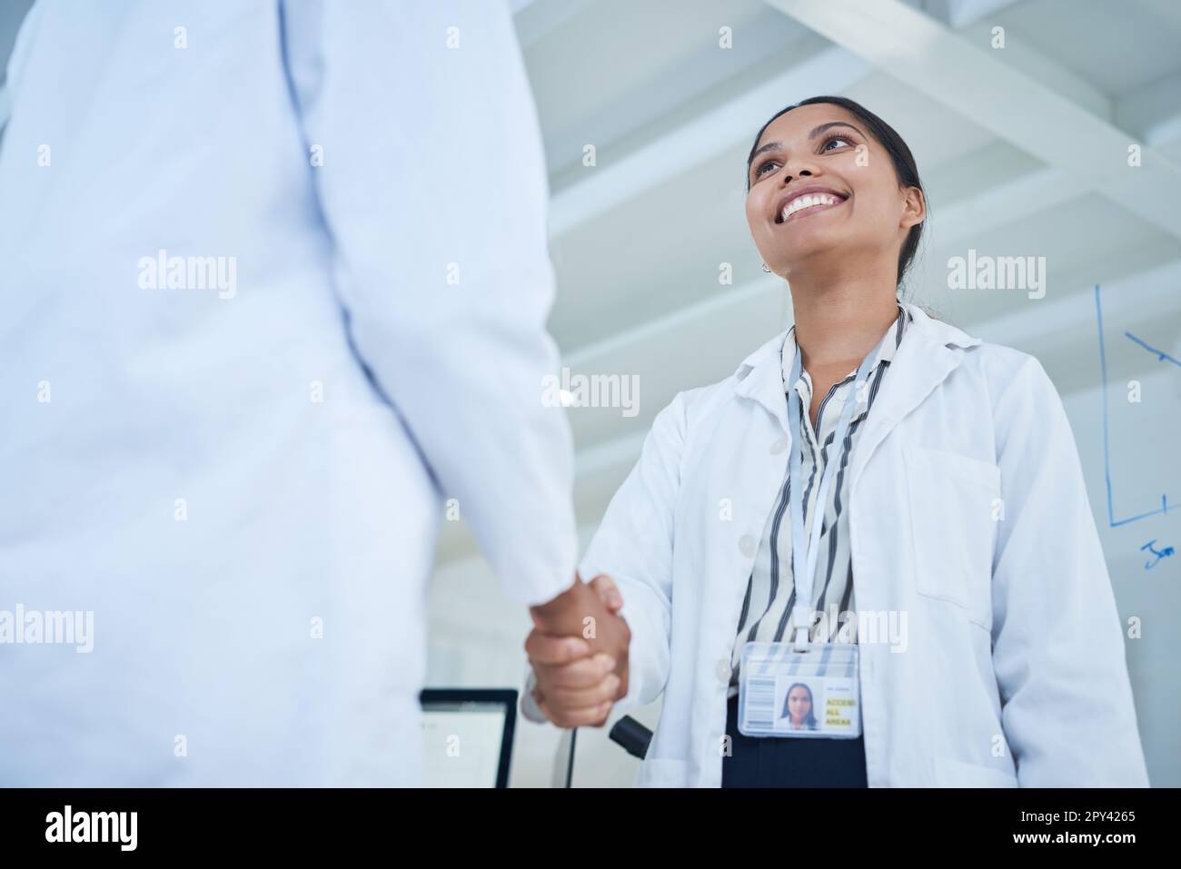 Two scientists shaking hands in hi-res stock photography and images - Alamy