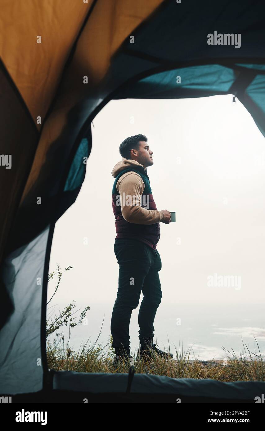 Nature invites us to be what we are. a young man drinking coffee while ...