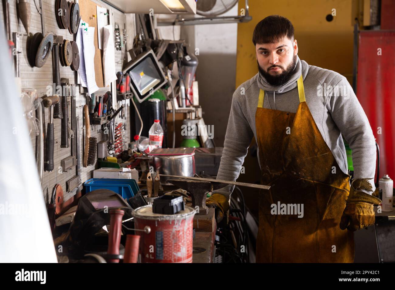 Professional man worker during work with steel in workshop Stock Photo ...