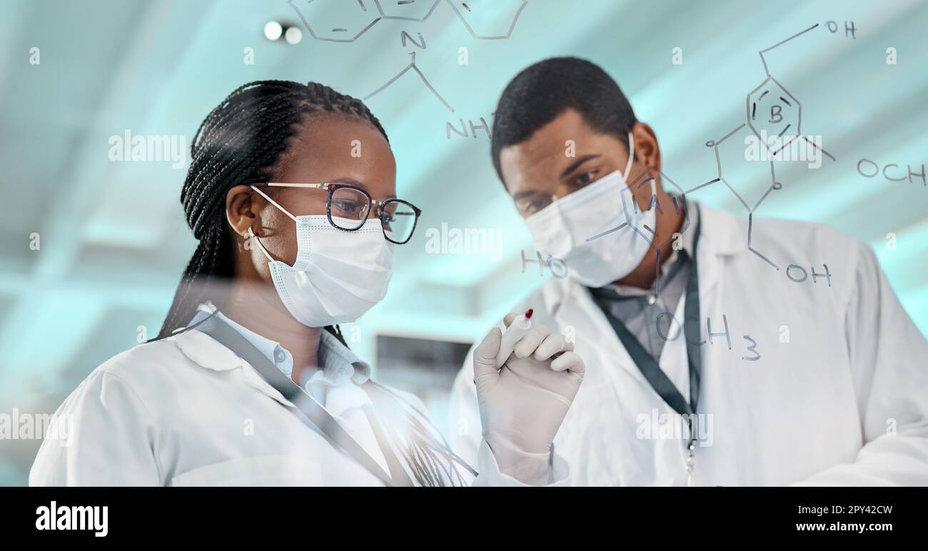 Testing a new formula. two scientists drawing molecular structures on a ...