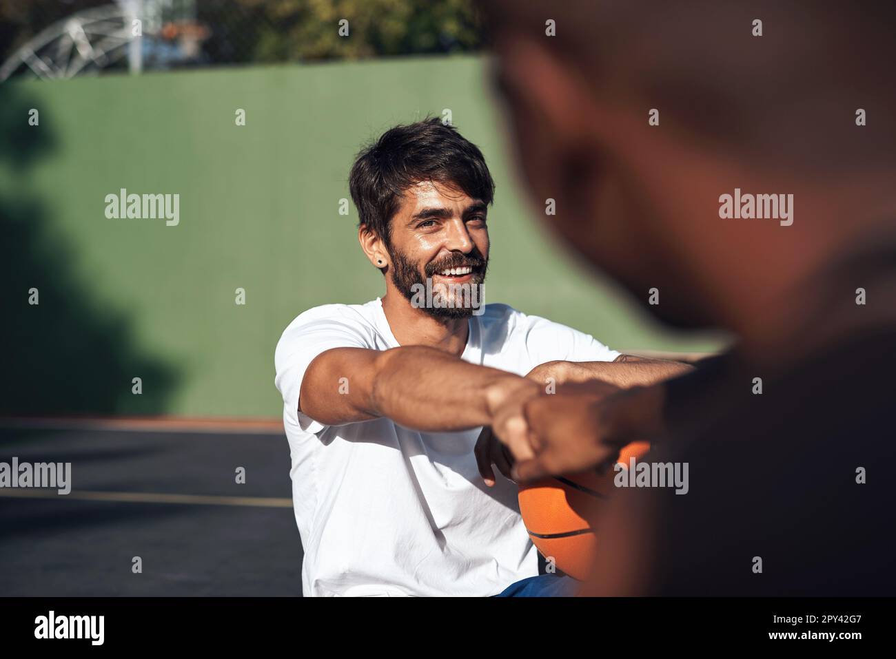 Your skills on the court are so good. a sporty young man giving his ...