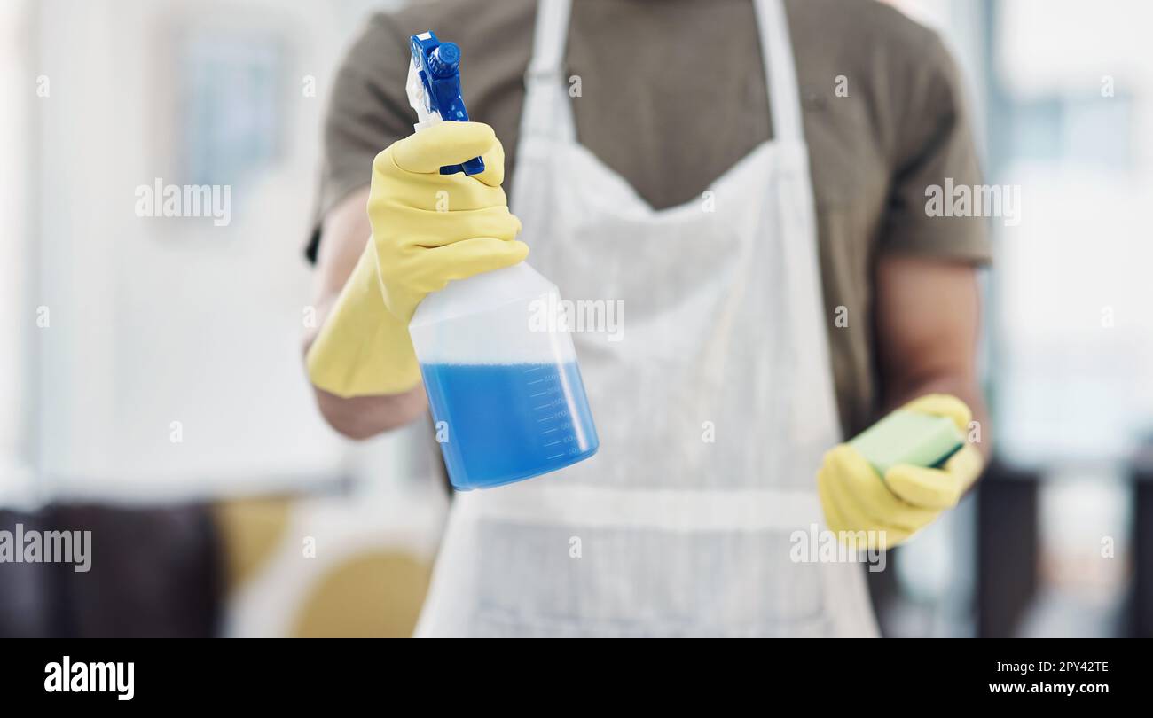 Keeping home a germ free zone. an unrecognisable man using rubber ...