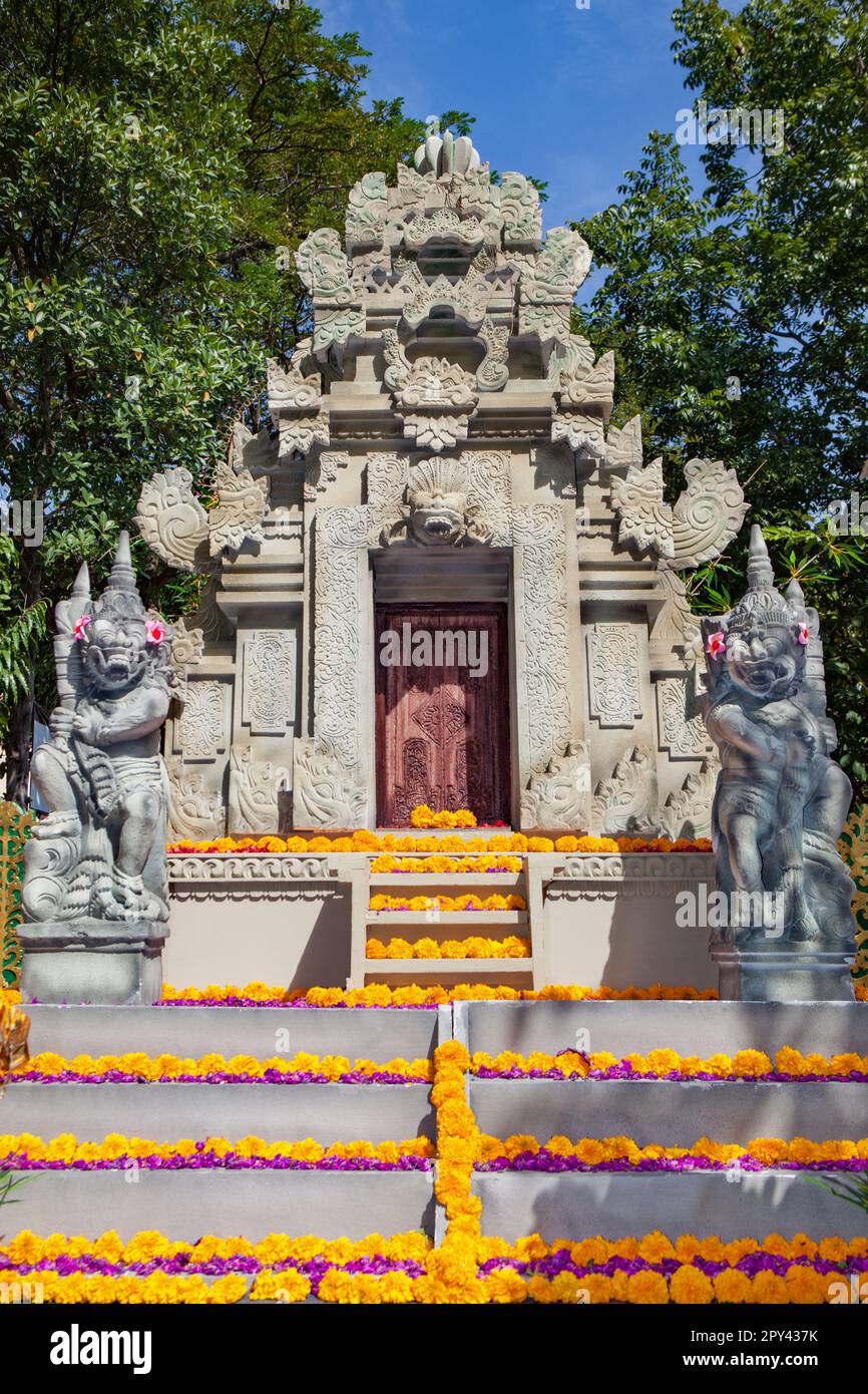 Traditional Balinese temple with guard spirits. Decorated by flowers ...