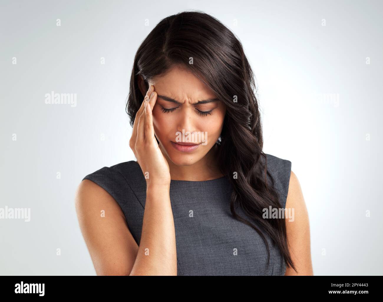 I almost never get headaches. a young woman suffering from a headache ...