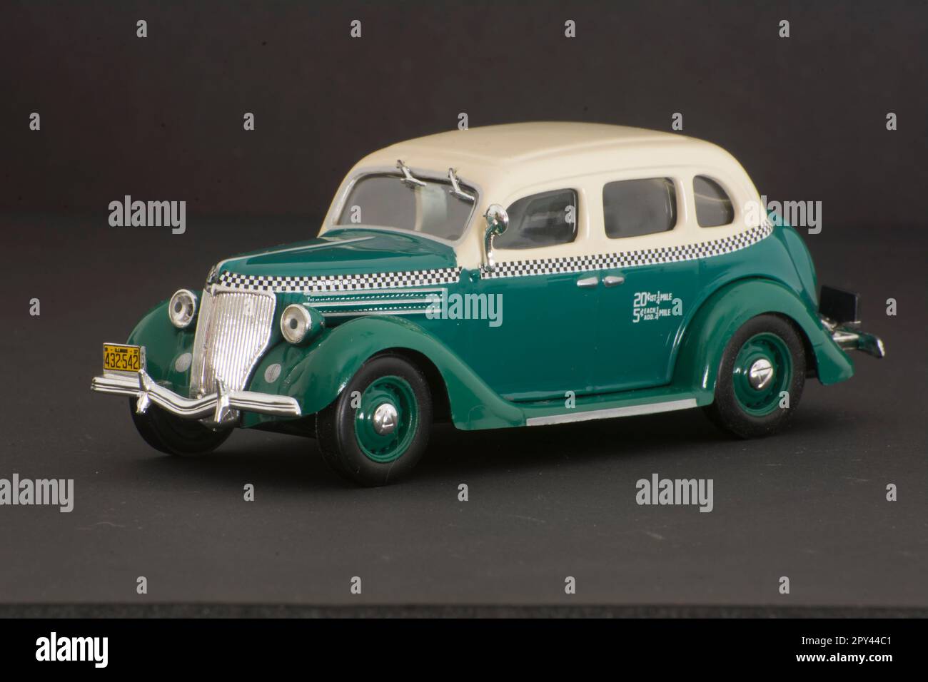 green and cream beautiful old vintage miniature cab against dark ...