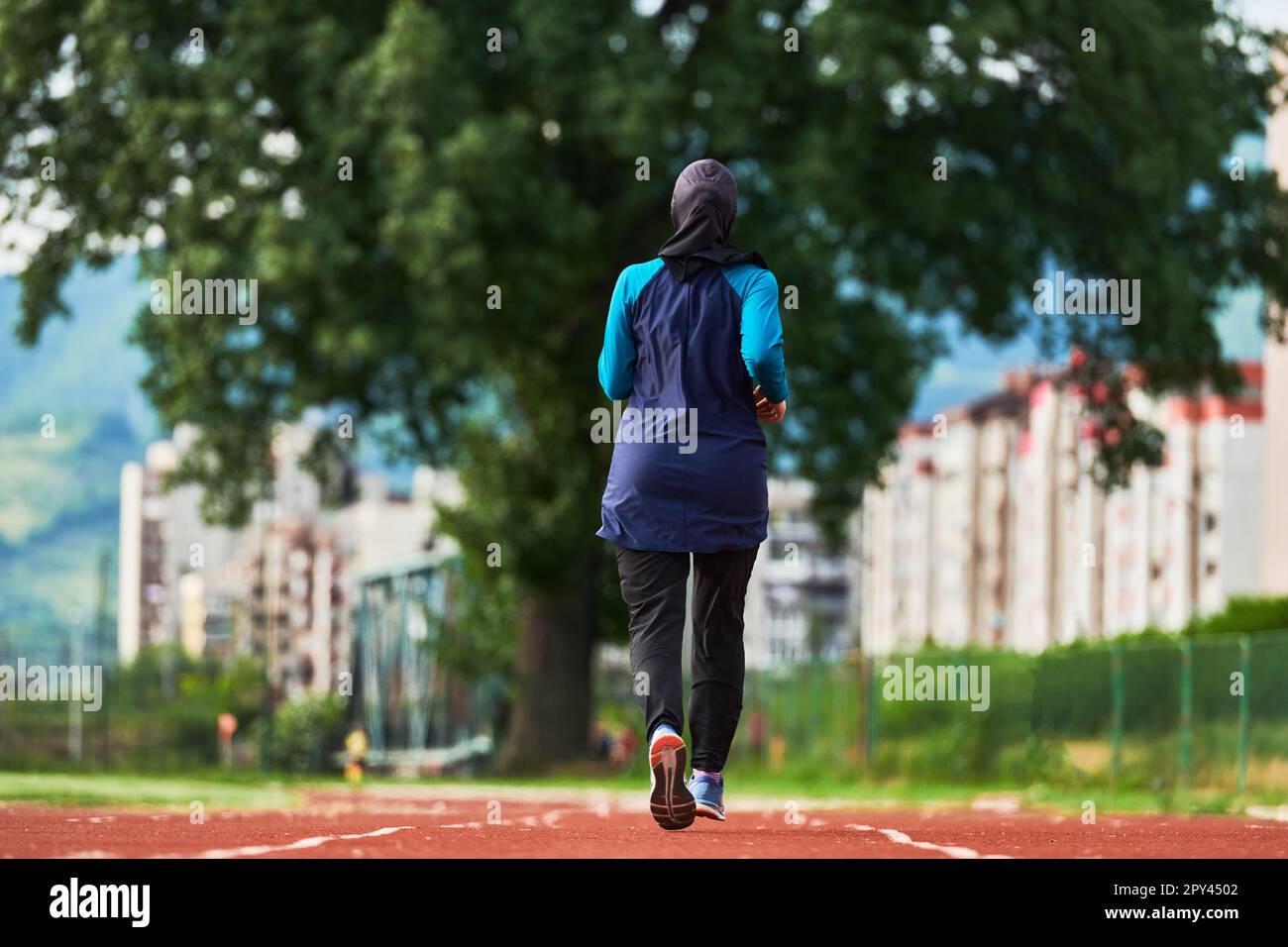 A muslim woman in a burqa sports muslim clothes running on a marathon ...