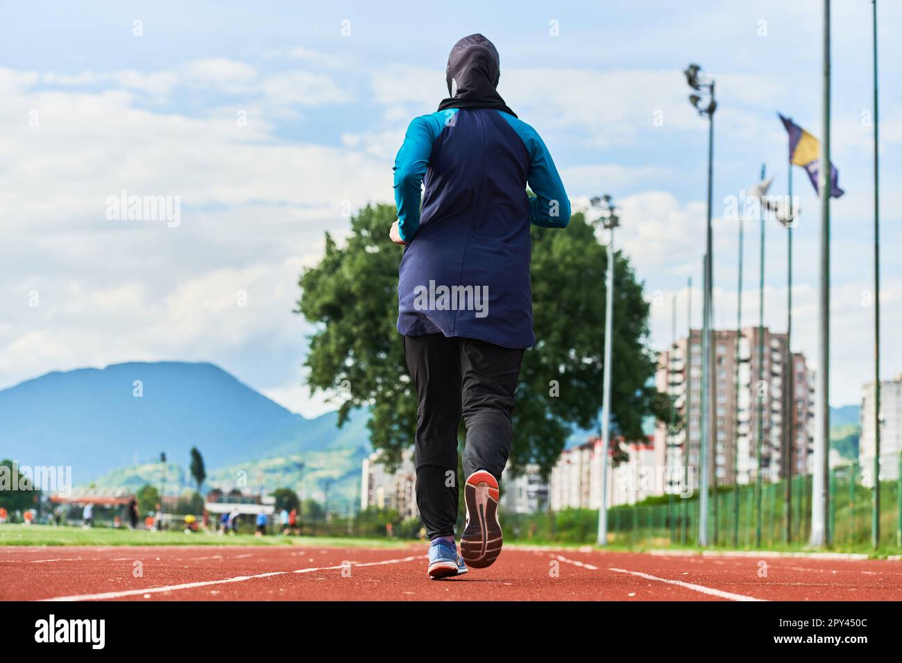 A muslim woman in a burqa sports muslim clothes running on a marathon ...