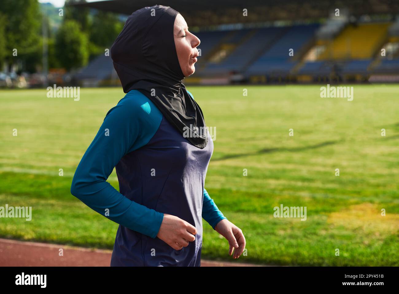 A muslim woman in a burqa sports muslim clothes running on a marathon ...