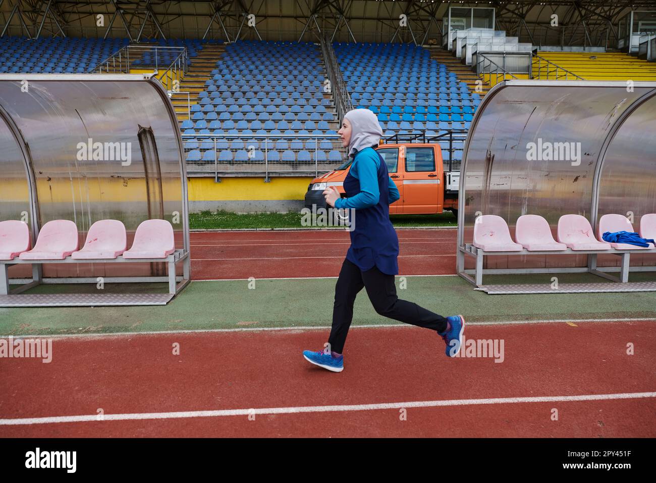 A muslim woman in a burqa sports muslim clothes running on a marathon ...
