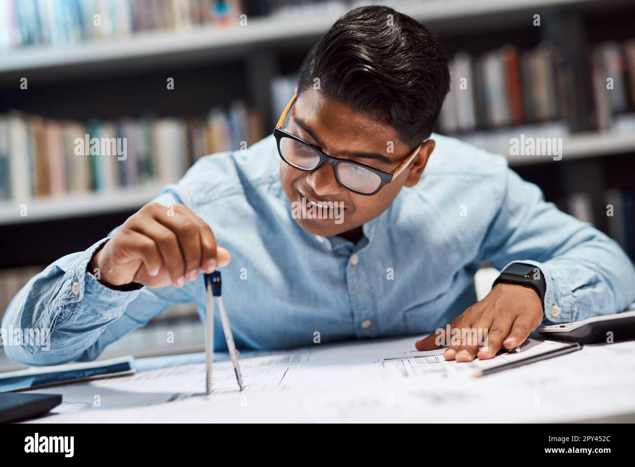 Brilliance encompasses his brand. a young architect using a compass to ...