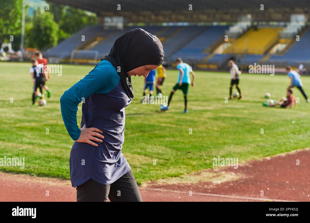 A Muslim woman with a burqa, an Islamic sportswoman resting after a ...