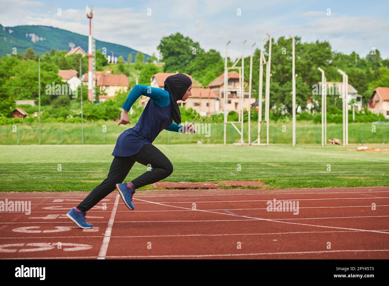 A muslim woman in a burqa sports muslim clothes running on a marathon ...