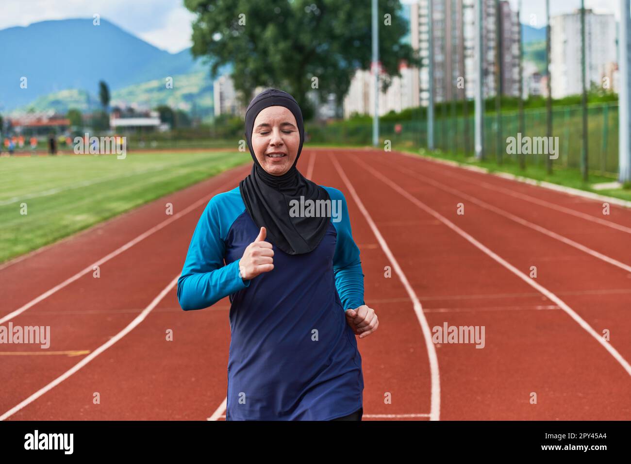 A muslim woman in a burqa sports muslim clothes running on a marathon ...