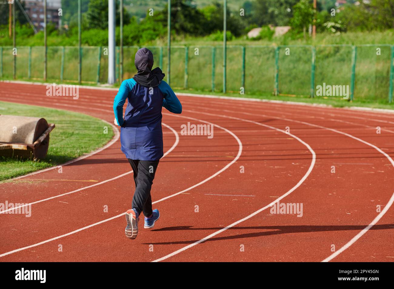 A muslim woman in a burqa sports muslim clothes running on a marathon ...