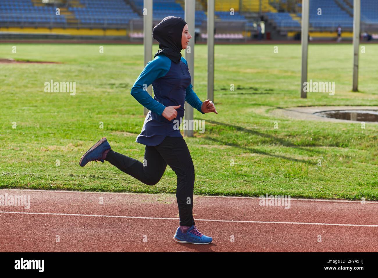 A muslim woman in a burqa sports muslim clothes running on a marathon ...