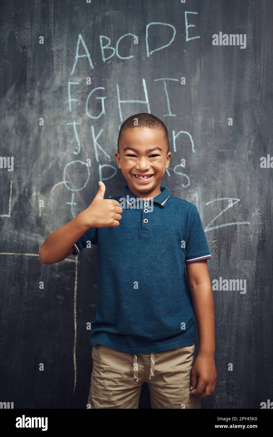 I can read and write the whole alphabet. a young boy showing thumbs up ...