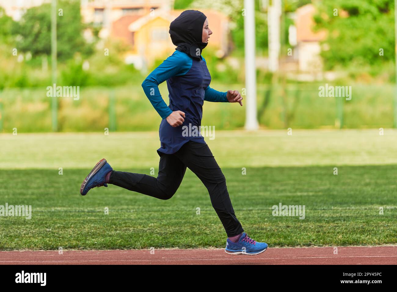 A muslim woman in a burqa sports muslim clothes running on a marathon ...