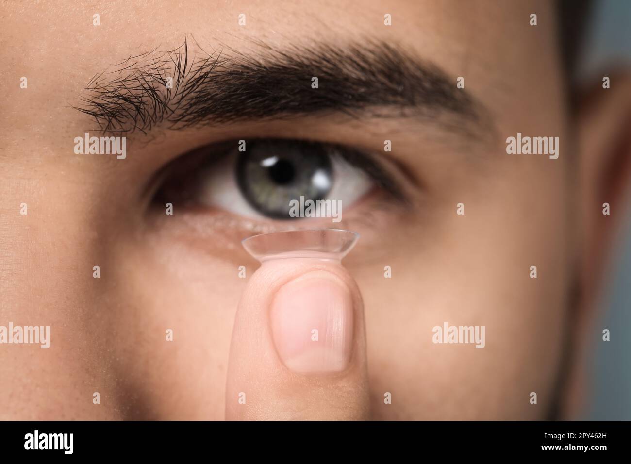 Young man contact lens hi-res stock photography and images - Alamy