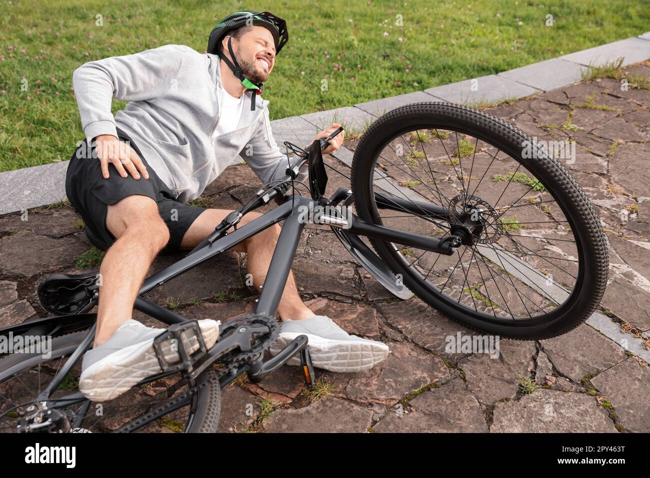 Man fallen off his bicycle in park Stock Photo - Alamy
