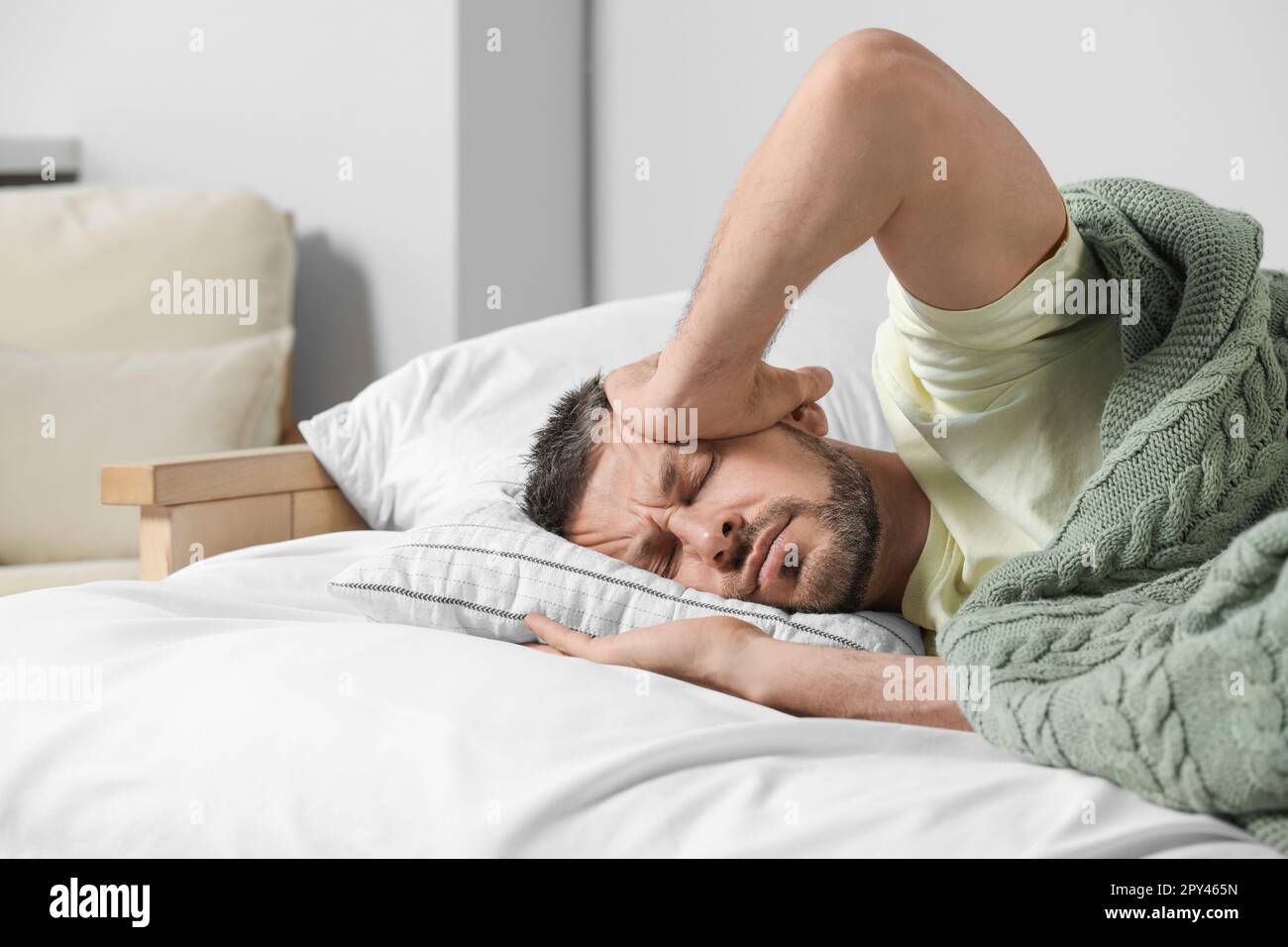 Sleepless man lying in bed at home Stock Photo - Alamy